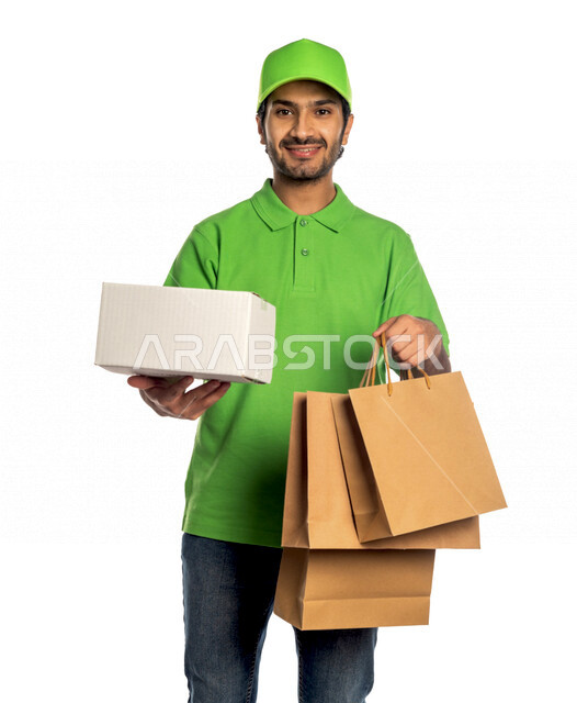 Portrait of a Saudi Arabian Gulf man wearing a green hat working in the ...
