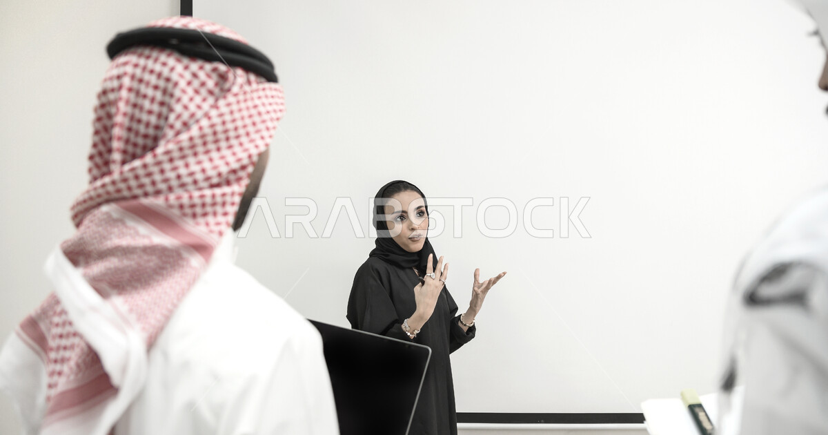 A Saudi Arabian Gulf university professor explains to her students the ...