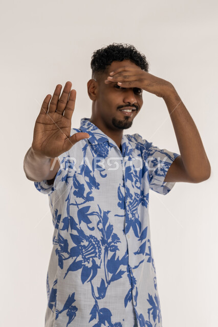 Refraining from doing something, a Saudi man raising his hand up with ...