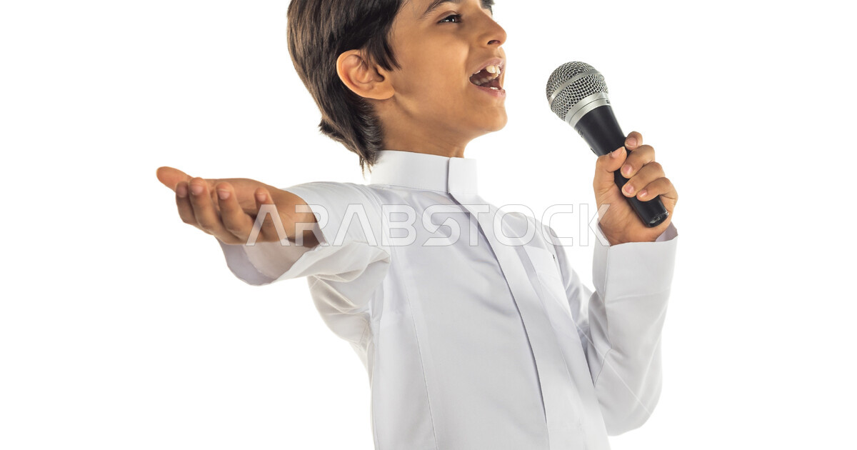 Portrait of a happy Gulf Arab Saudi Arabian child, holding the ...