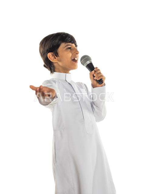 Portrait of a happy Gulf Arab Saudi Arabian child, holding the ...