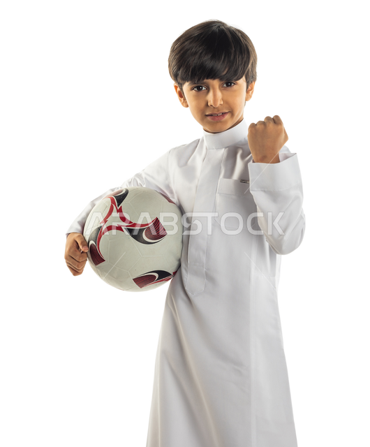Portrait of a Saudi Arabian Gulf boy holding a football in his hand ...