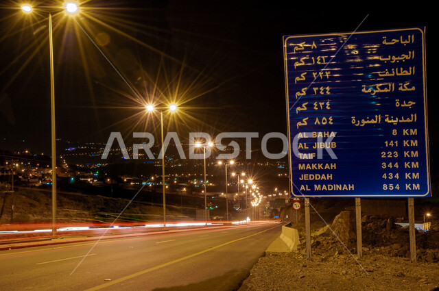 Directional sign in Arabic and English on a road in Al Baha region at ...