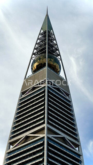 A tower with a pyramidal design with curved edges, a close-up of Al ...