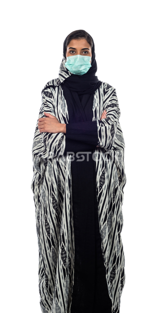 Portrait of a Saudi Arabian Gulf woman wearing a protective mask ...