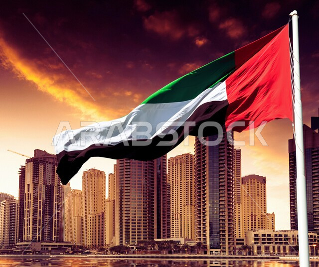 UAE flag waving in the sky, national slogans and symbols, urban growth ...