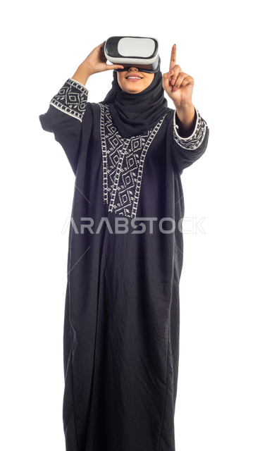 Portrait of a Saudi Arabian Gulf woman wearing a VR pointing with her ...