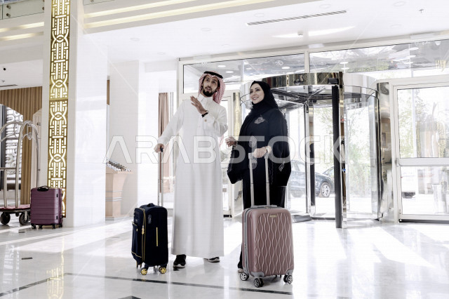 A Saudi Arabian couple tourists enter the tourist hotel to spend the ...