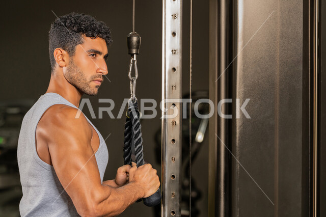 Bodybuilding, Saudi man doing muscle strengthening activities, gestures ...