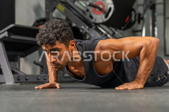 Emirati Gulf Arab man wearing sportswear doing push-ups, Saudi young ...