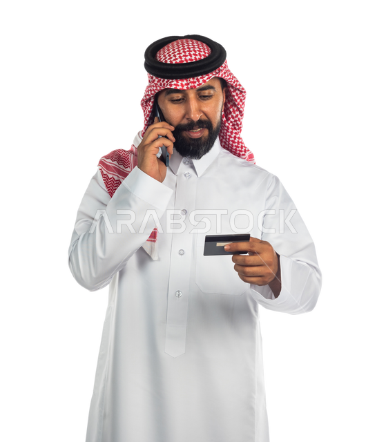 Portrait of a Saudi Arabian Gulf man using a bank credit card in online ...