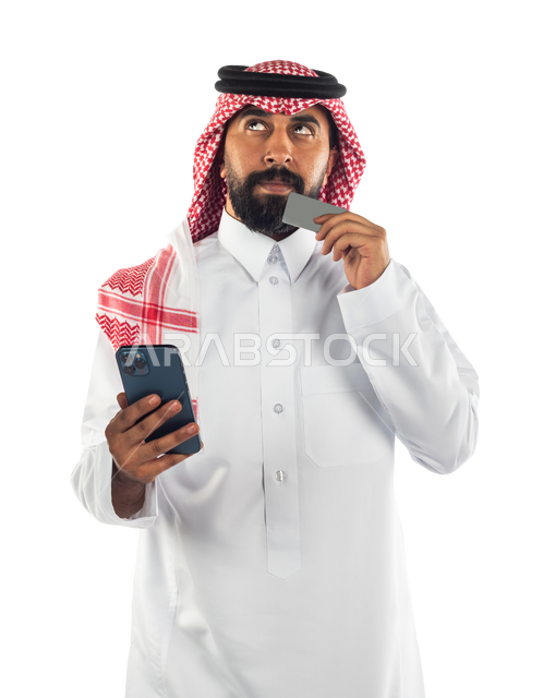 Portrait of a Saudi Arabian Gulf man using a bank credit card in online ...