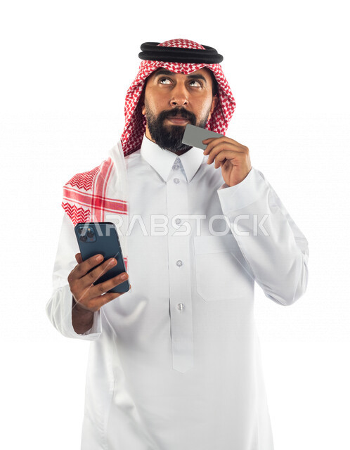 Portrait of a Saudi Arabian Gulf man using a bank credit card in online ...