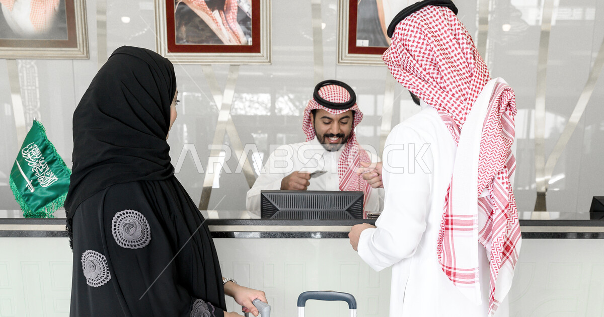 A Saudi couple tourists who make the reservation procedures at the ...