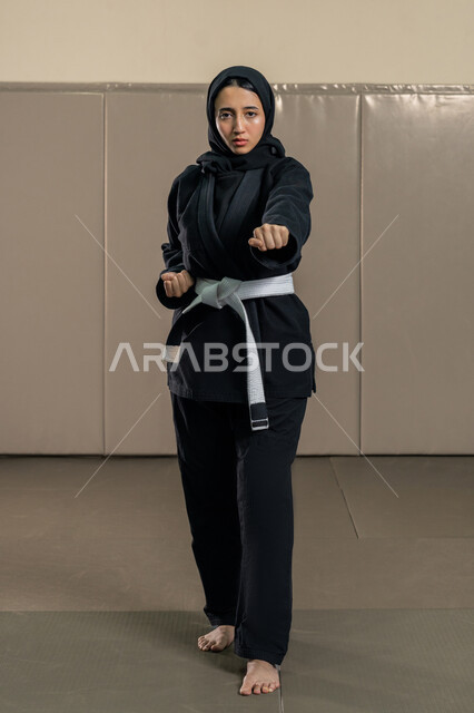 Performing karate martial arts moves, a veiled Saudi Arabian Gulf young ...
