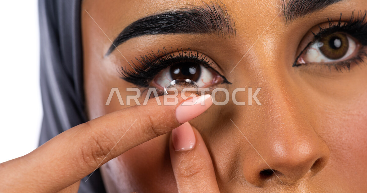 Close-up portrait of a Saudi Arabian Gulf woman who puts cosmetic ...
