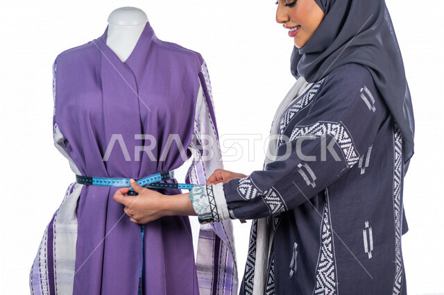 Portrait of a Saudi Arabian Gulf fashion designer working on taking ...