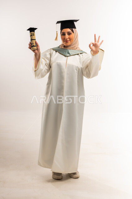 Quality and excellence mark, Saudi young woman celebrating completion ...