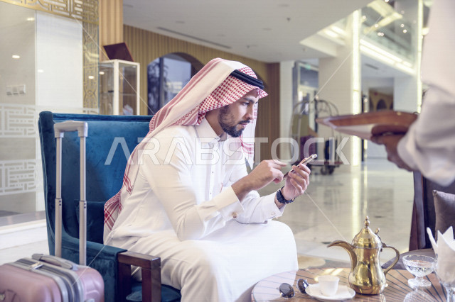 A Saudi Arabian Gulf tourist sitting in the waiting room in the hotel ...