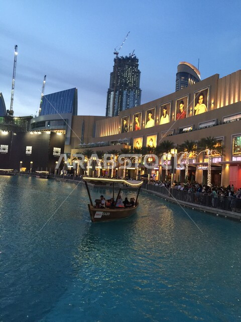 Wooden boat in the water, water ride in front of Dubai Mall, a famous ...