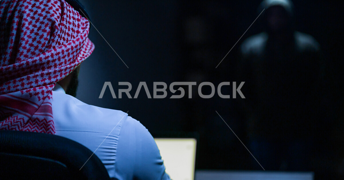 A Saudi Arabian Gulf man using his laptop, exposure to hacking and ...