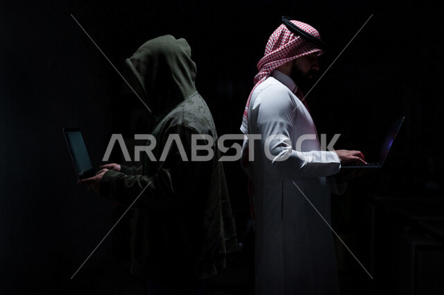 A Saudi Arabian Gulf man using his laptop, exposure to hacking and ...
