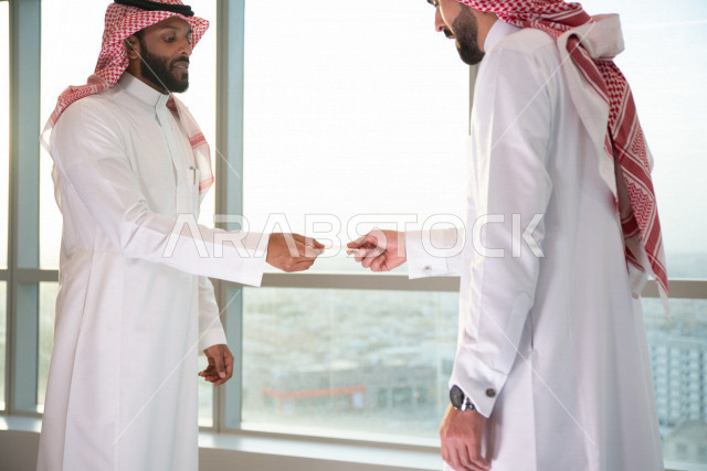 Saudi Gulf businessman Saeed, delivers the customer the company card ...