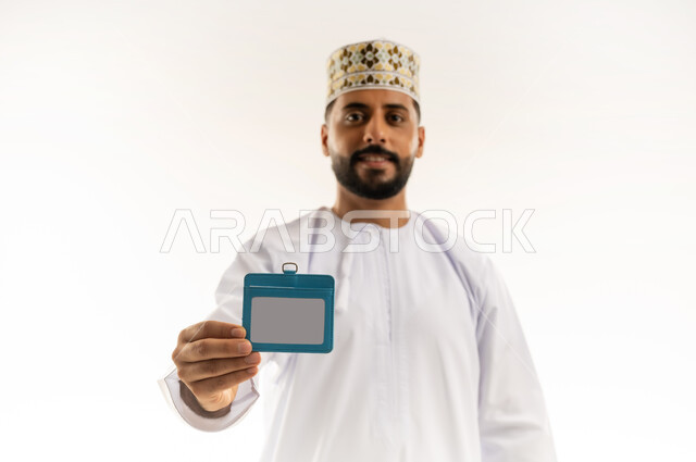 ID card display, close-up portrait of young Omani Gulf Arab man wearing ...