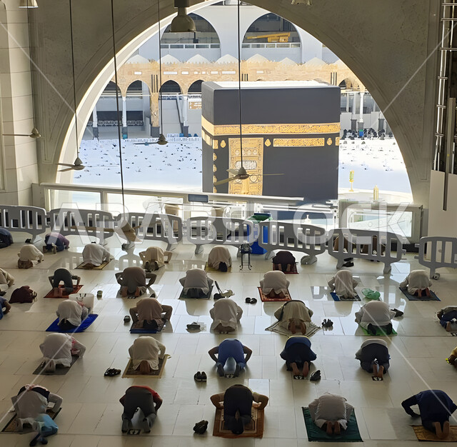 Qibla of Islam and Muslims, a picture from the back of pilgrims praying ...