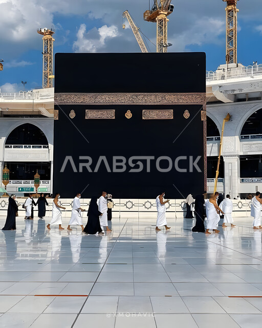 A group of pilgrims performing Tawaf around the Kaaba in the courtyard ...