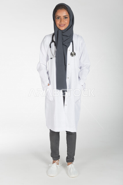 Portrait of a Saudi Arabian Gulf doctor putting her hand on the pocket ...