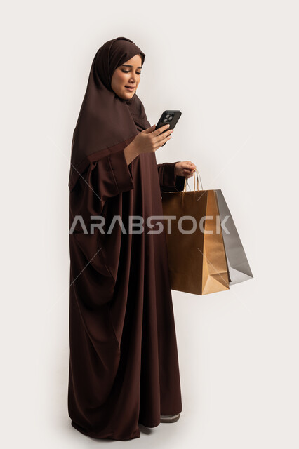 Saudi woman shopping online for groceries and gifts, portrait of an ...