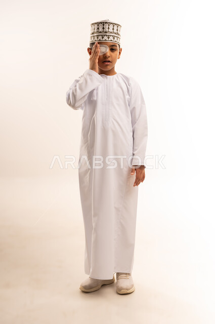 Health and disease concept, portrait of an Arab Gulf Omani boy wearing ...
