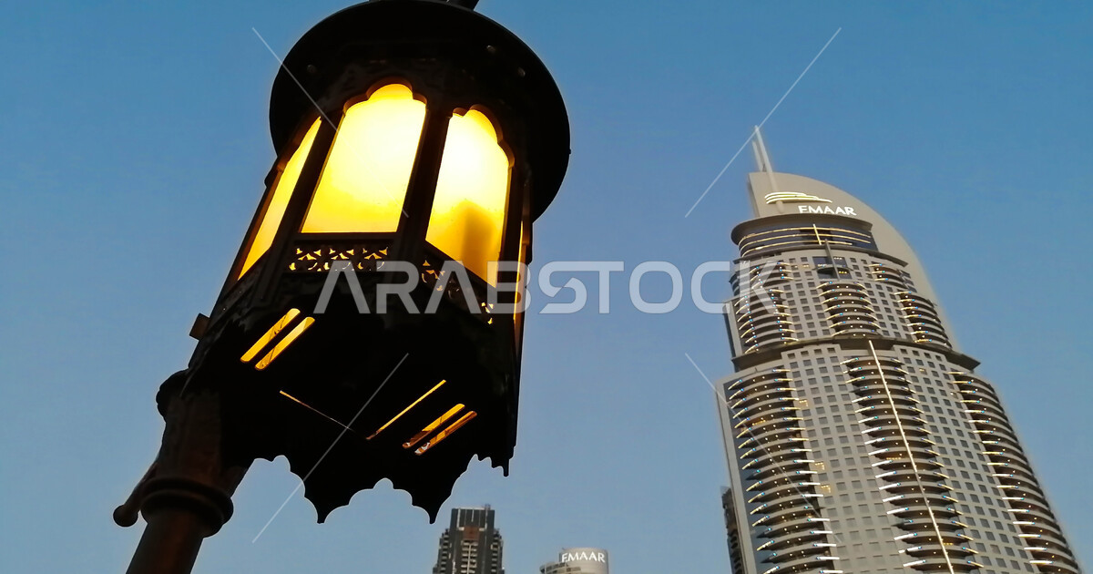 A close-up of one of the lights near the Dubai Towers at sunset, a ...