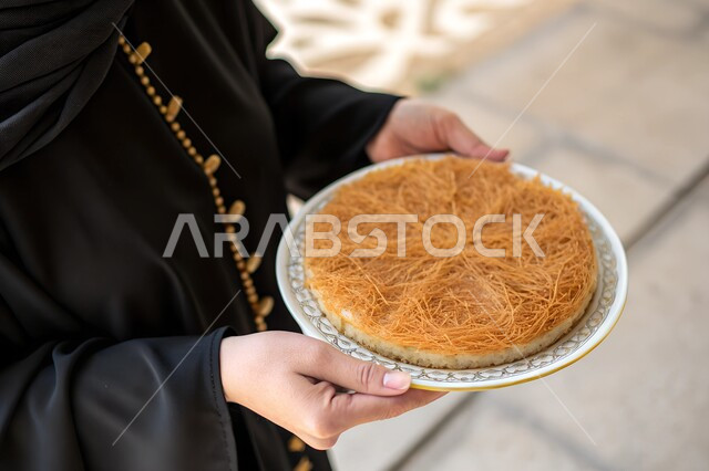 Arabic sweets with syrup, close-up of a Saudi Arabian Gulf woman's hand ...