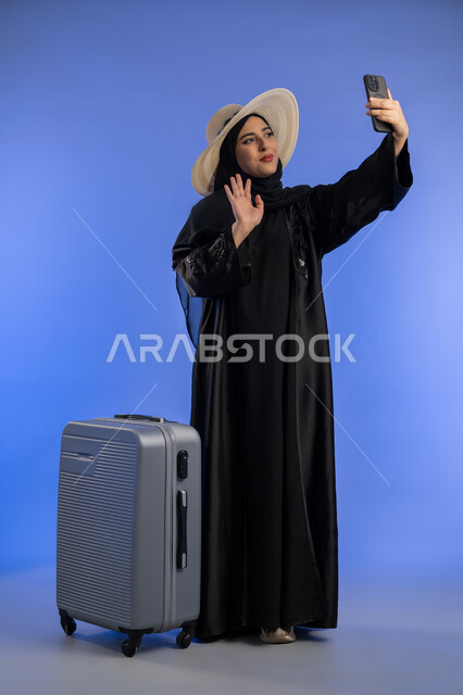 Integrating technology into daily life, portrait of a veiled Emirati ...