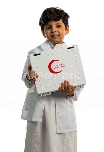 Portrait of a smiling Saudi Arabian Gulf Arab boy, looking at the ...