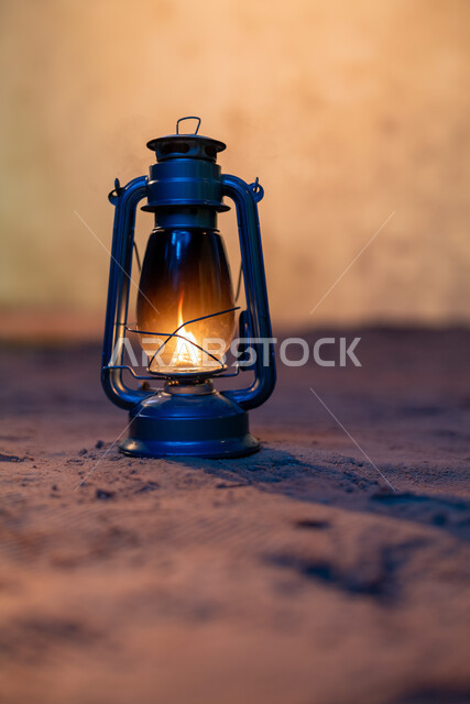 An old-fashioned lamp made of copper, a popular lantern on the ground ...