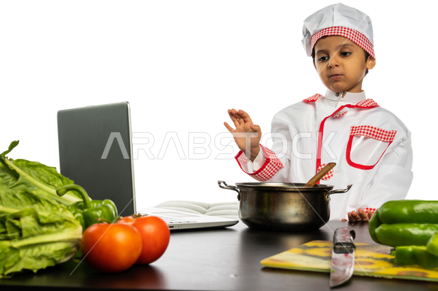 Portrait of a Saudi Arabian Gulf boy, dressed in a special chef uniform ...