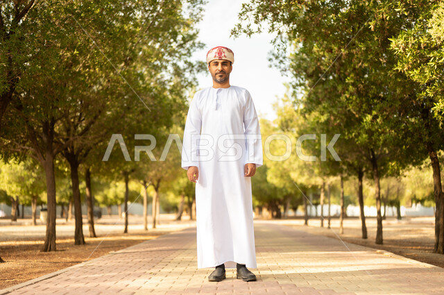 Having fun in green gardens, outdoor walk, an Arab Gulf Omani man ...