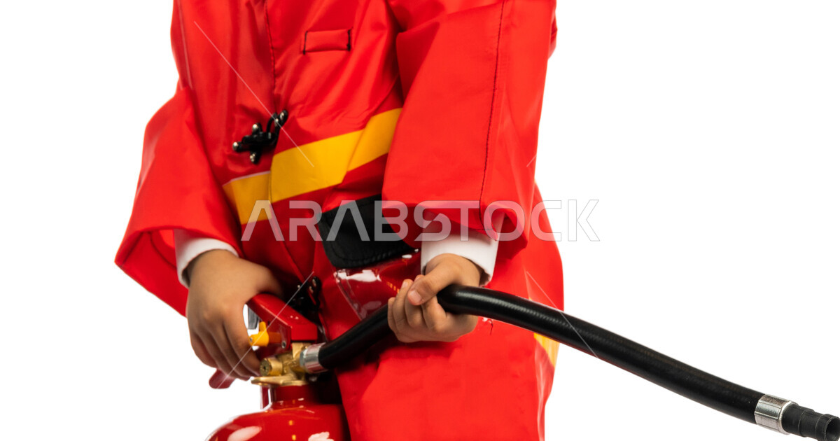 Portrait of a stylish Saudi Arabian Gulf boy, dressed as a fireman ...