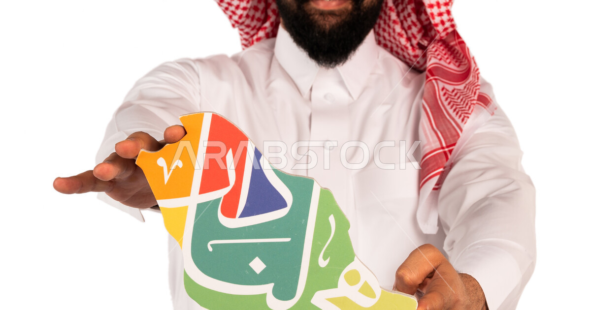 Portrait of a Saudi Gulf man in Saudi uniform, holding in his hand the ...