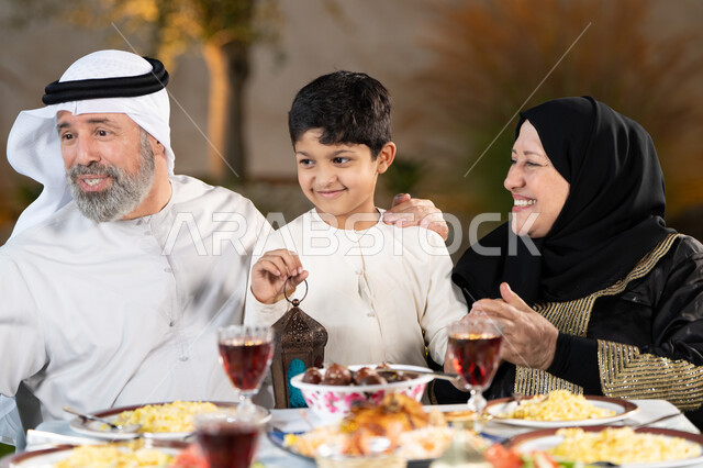 Islamic and Ramadan rituals, family gathering around the dining table ...