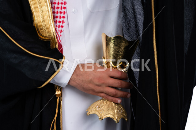 A portrait of a Saudi Arab groom holding an incense holder (censer ...