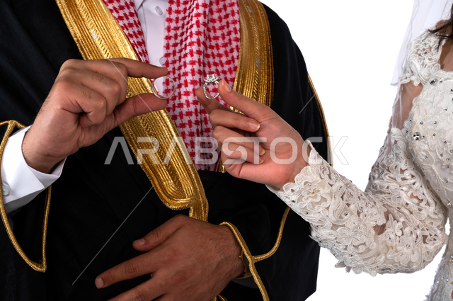 Close-up portrait of a groom in official Saudi attire, and a Saudi ...