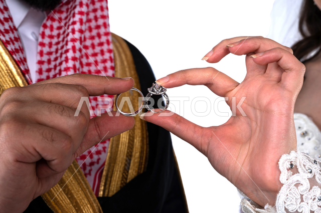 Close-up portrait of a groom in official Saudi attire, and a Saudi ...