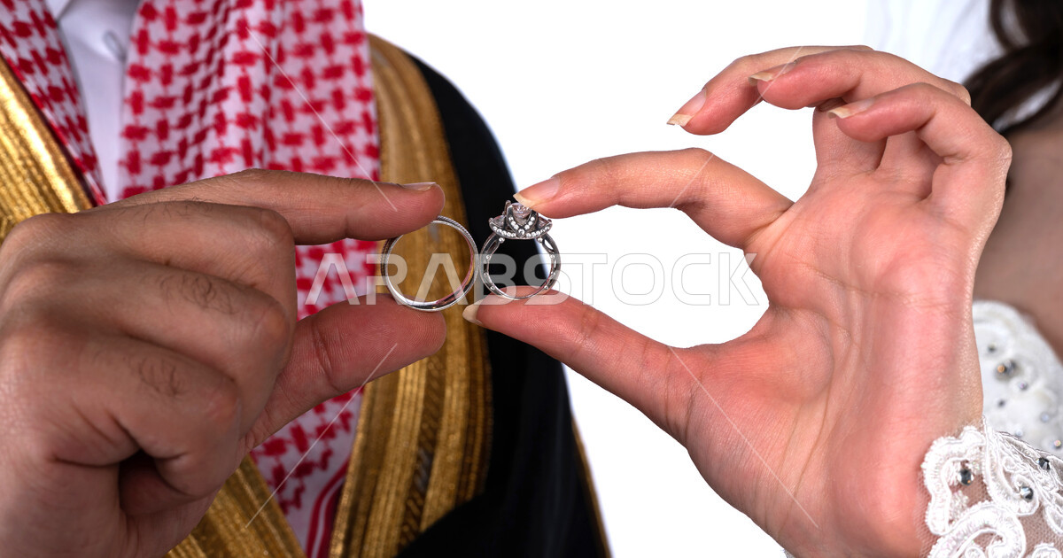 Close-up portrait of a groom in official Saudi attire, and a Saudi ...