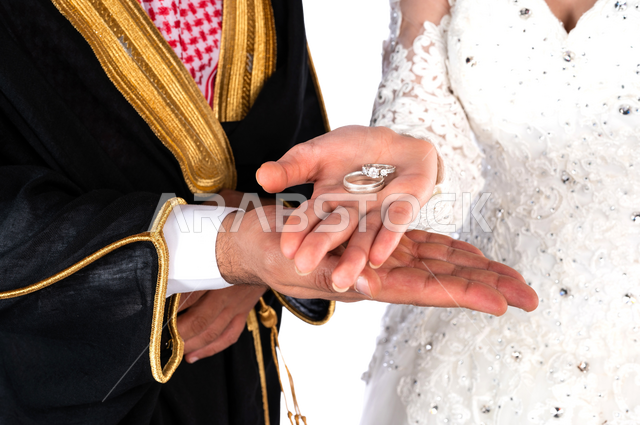 Close-up portrait of a groom in official Saudi attire, and a Saudi ...