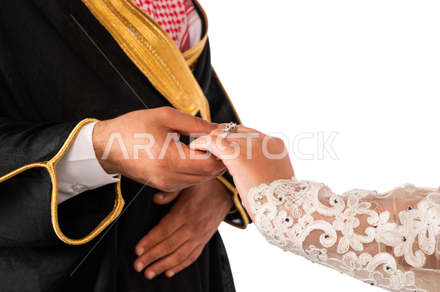 Close-up portrait of a groom in the official Saudi attire holding the ...