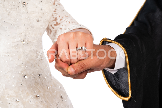 Close-up portrait of a groom in the official Saudi attire holding the ...